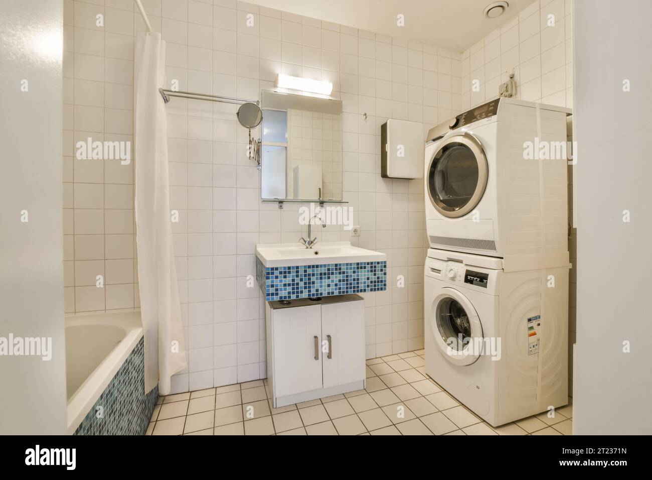 a laundry room with a washer, dryer and washing machine in the corner ...