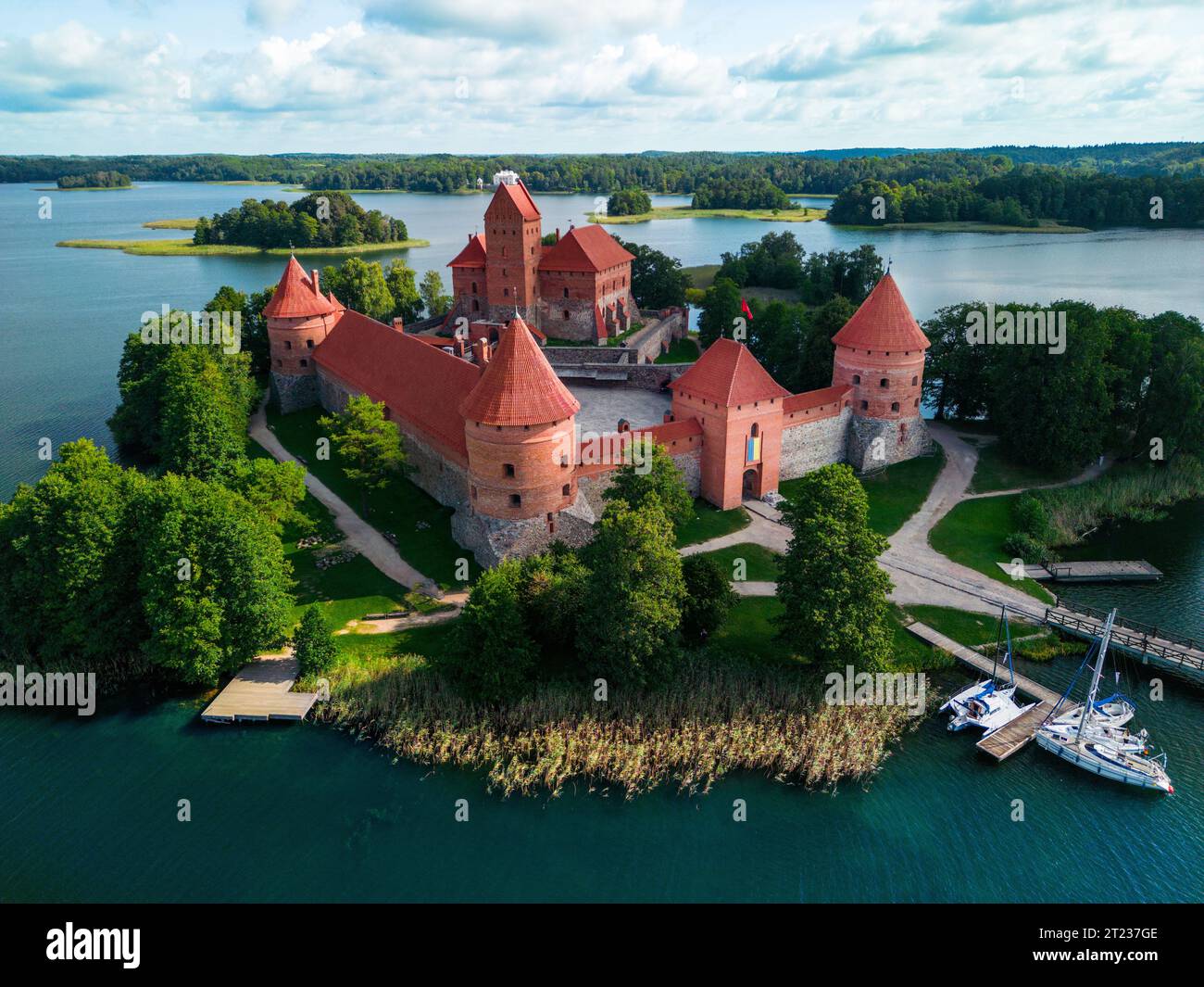 An aerial view of the historic Trakai Castle surrounded by water in ...