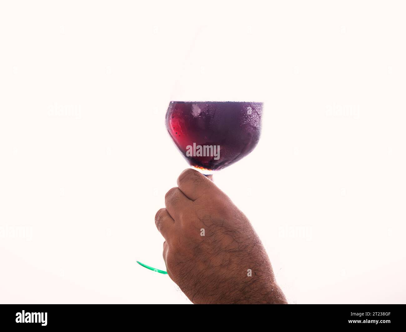 Adult caucasian man's hand drinking red wine from an invisible glass ...