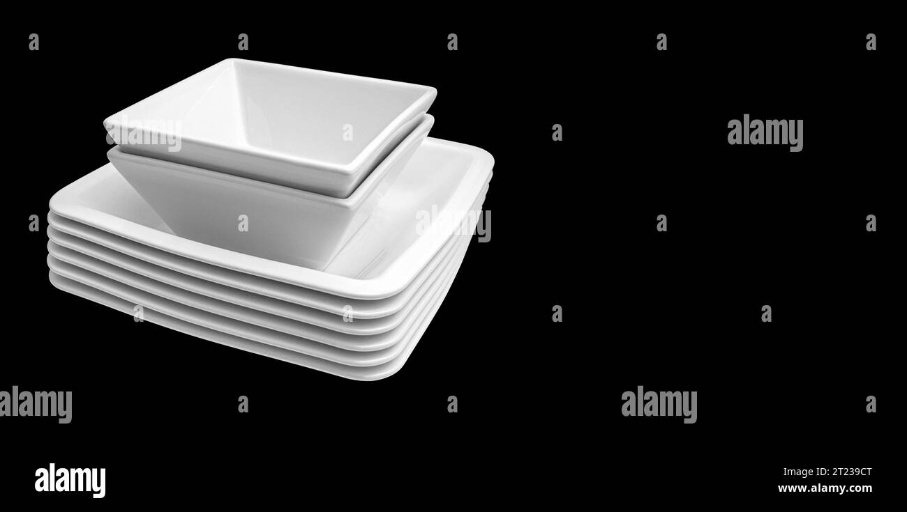 A stack of square white plates isolated on black background with copy ...