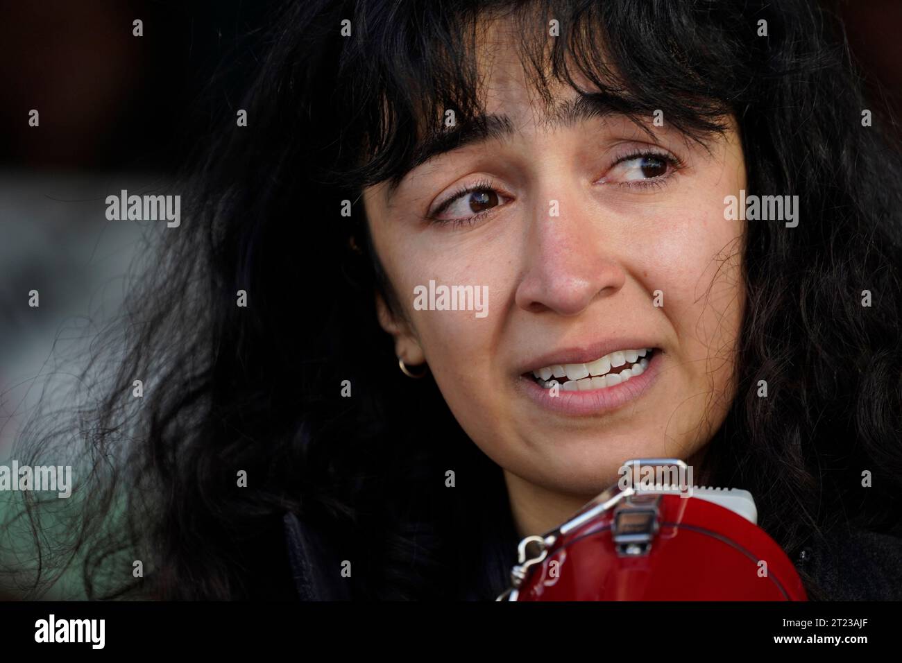 A tearful Delana Tavakol calls out for peace at a rally held by ...