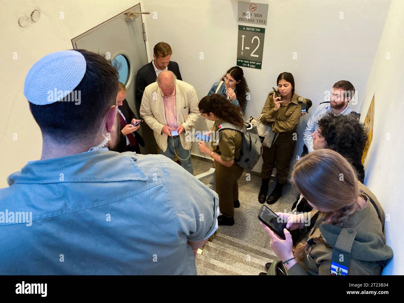 Members of the press and Israeli soldiers take shelter in a stairwell ...