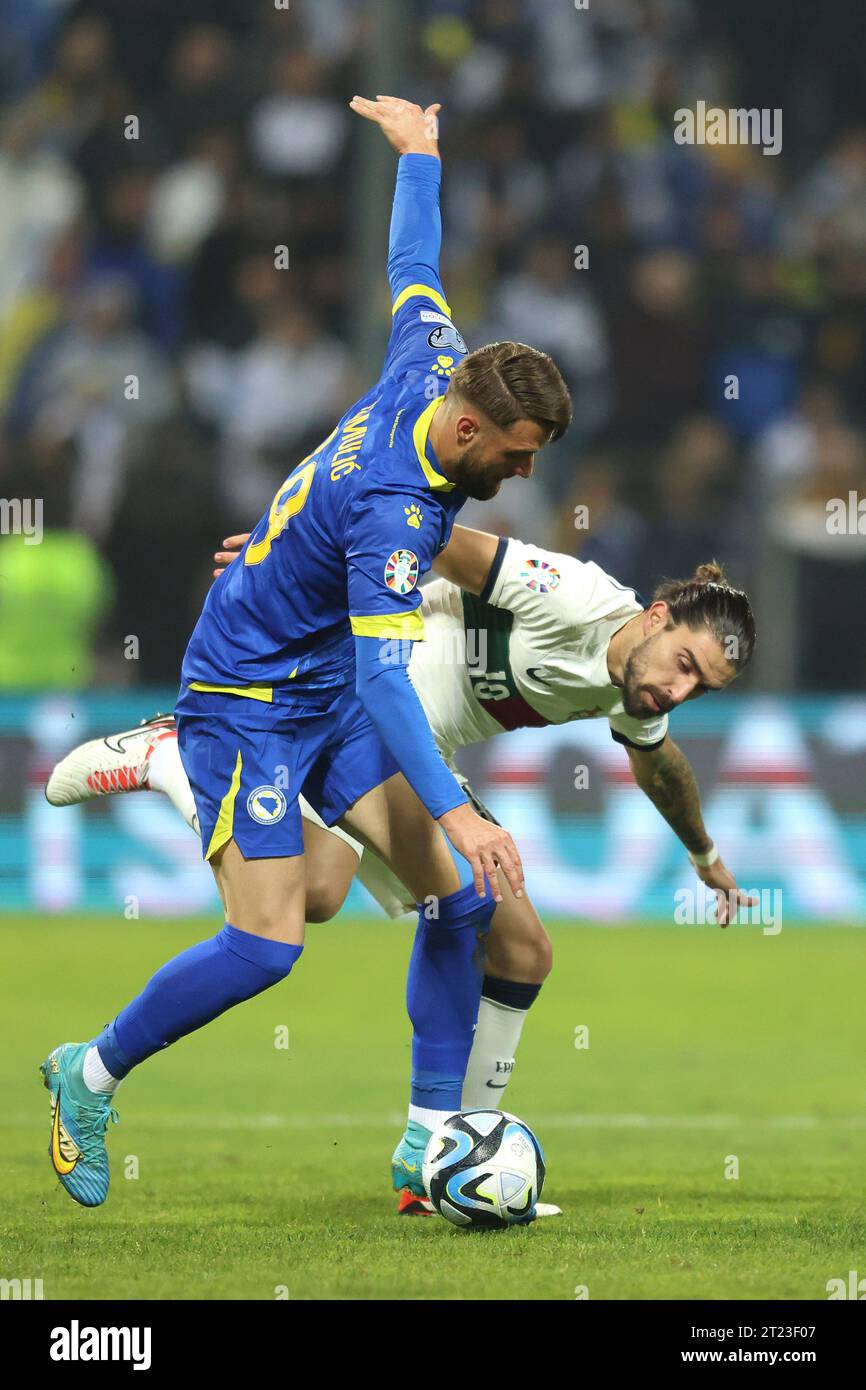 Bosnia's Said Hamulic, left, challenges for the ball with Portugal's ...