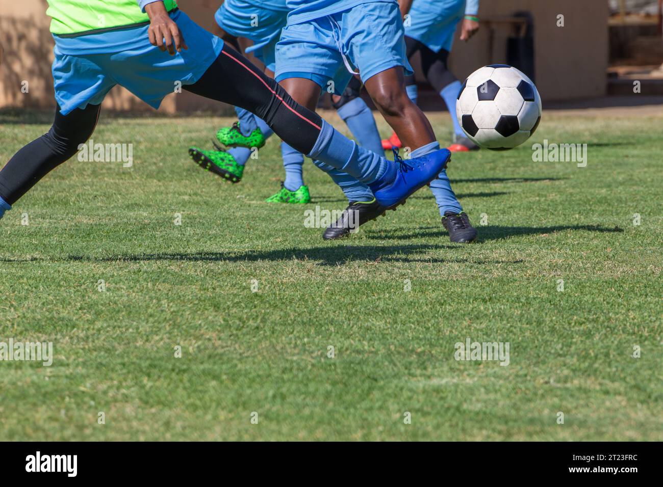 african players on the football, soccer field kicking the ball start of ...