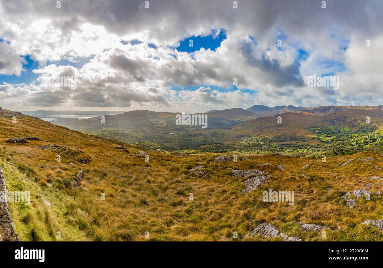 Typical Irish landscape with green meadows and rough mountains during ...
