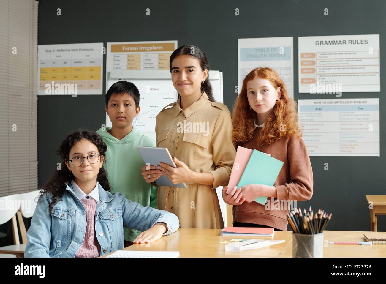 Three clever secondary school learners and teacher of English language ...