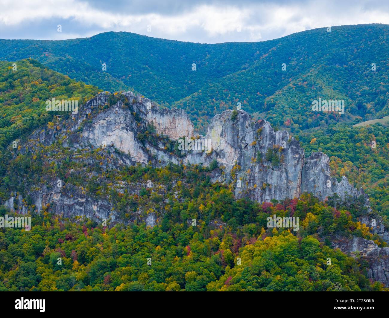 An aerial view of the Seneca Rocks with lush vegetation and clouds ...