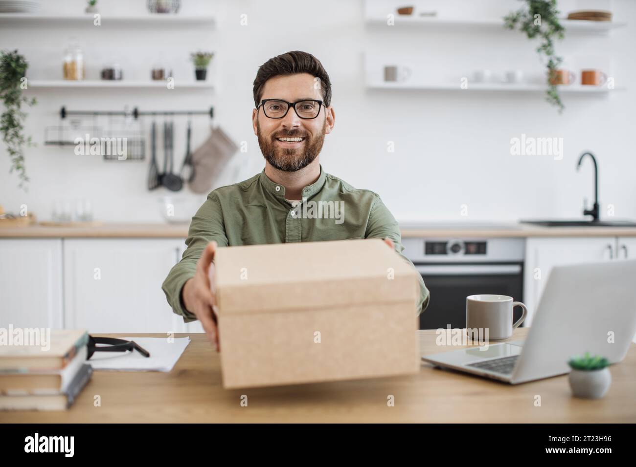 Smiling vlogger showing cardboard box with online order Stock Photo - Alamy