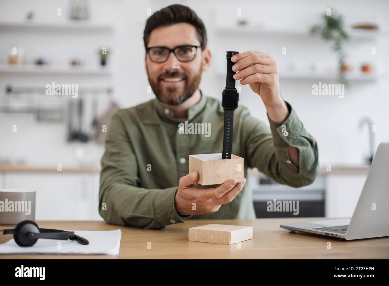 Male vlogger showing new smart watch during live streaming Stock Photo ...