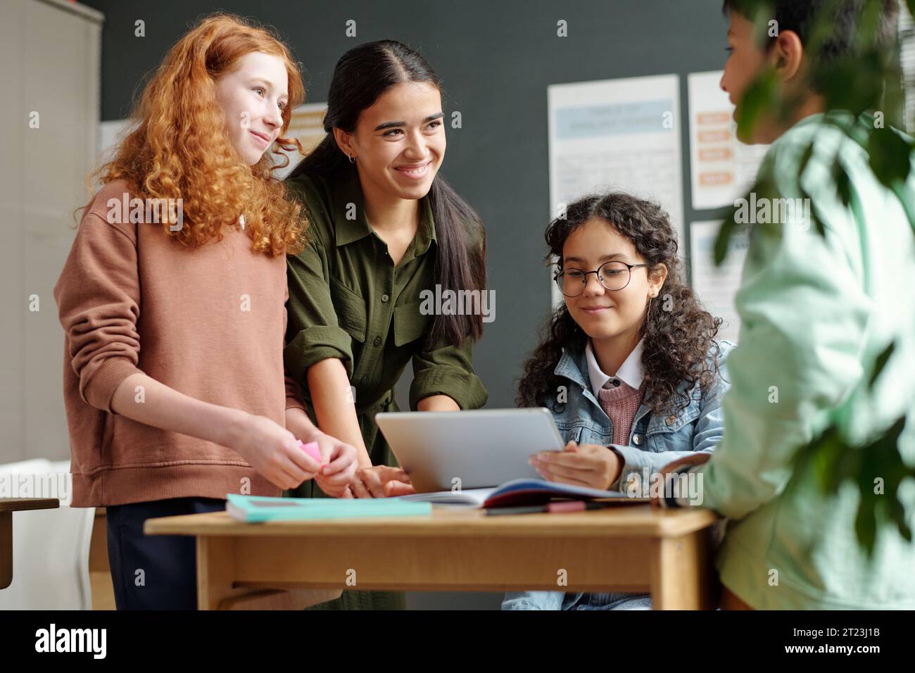 Clever classmates and their teacher of English grammar watching online ...