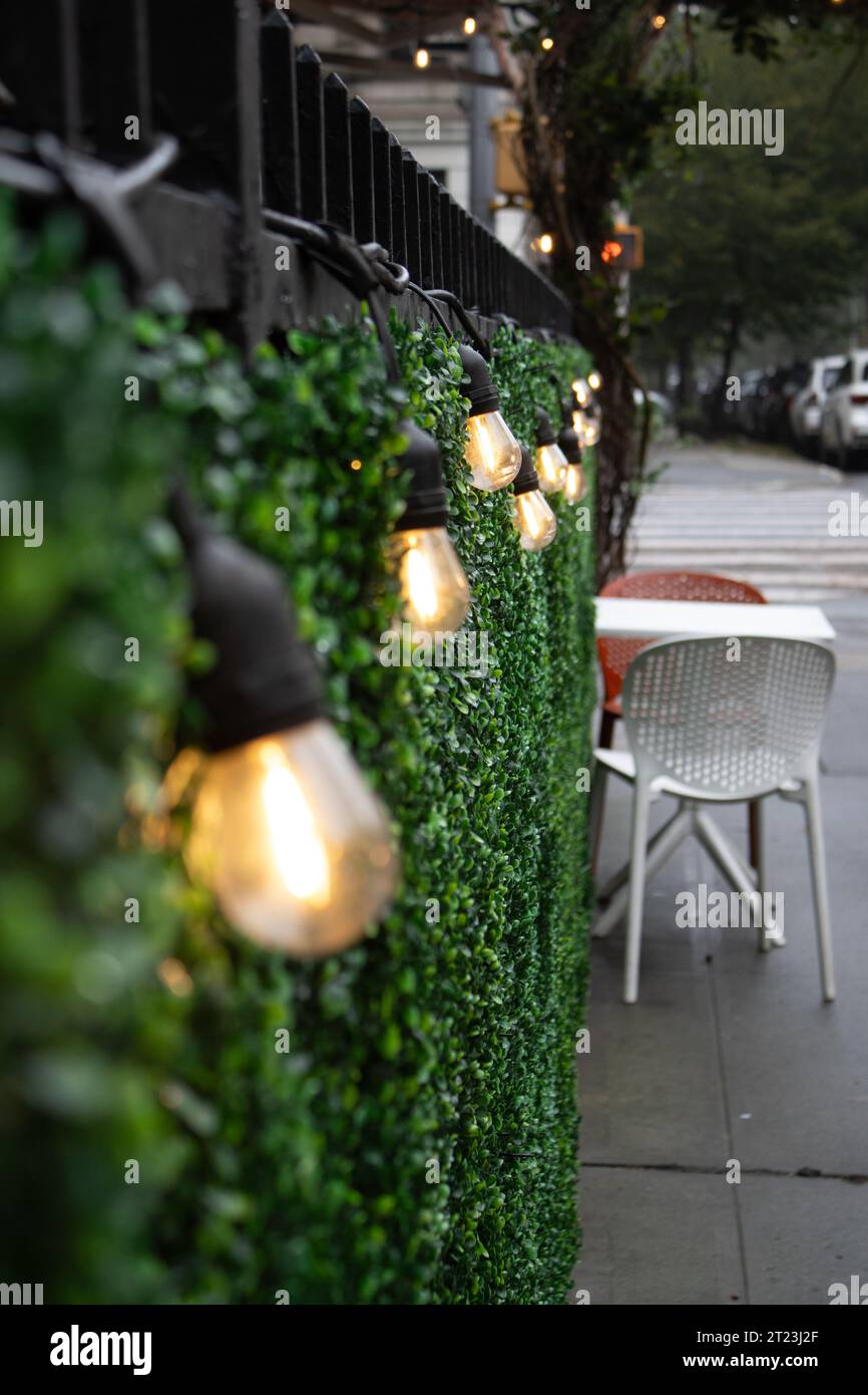 A caf in the city is illuminated with decorative string lights draped ...