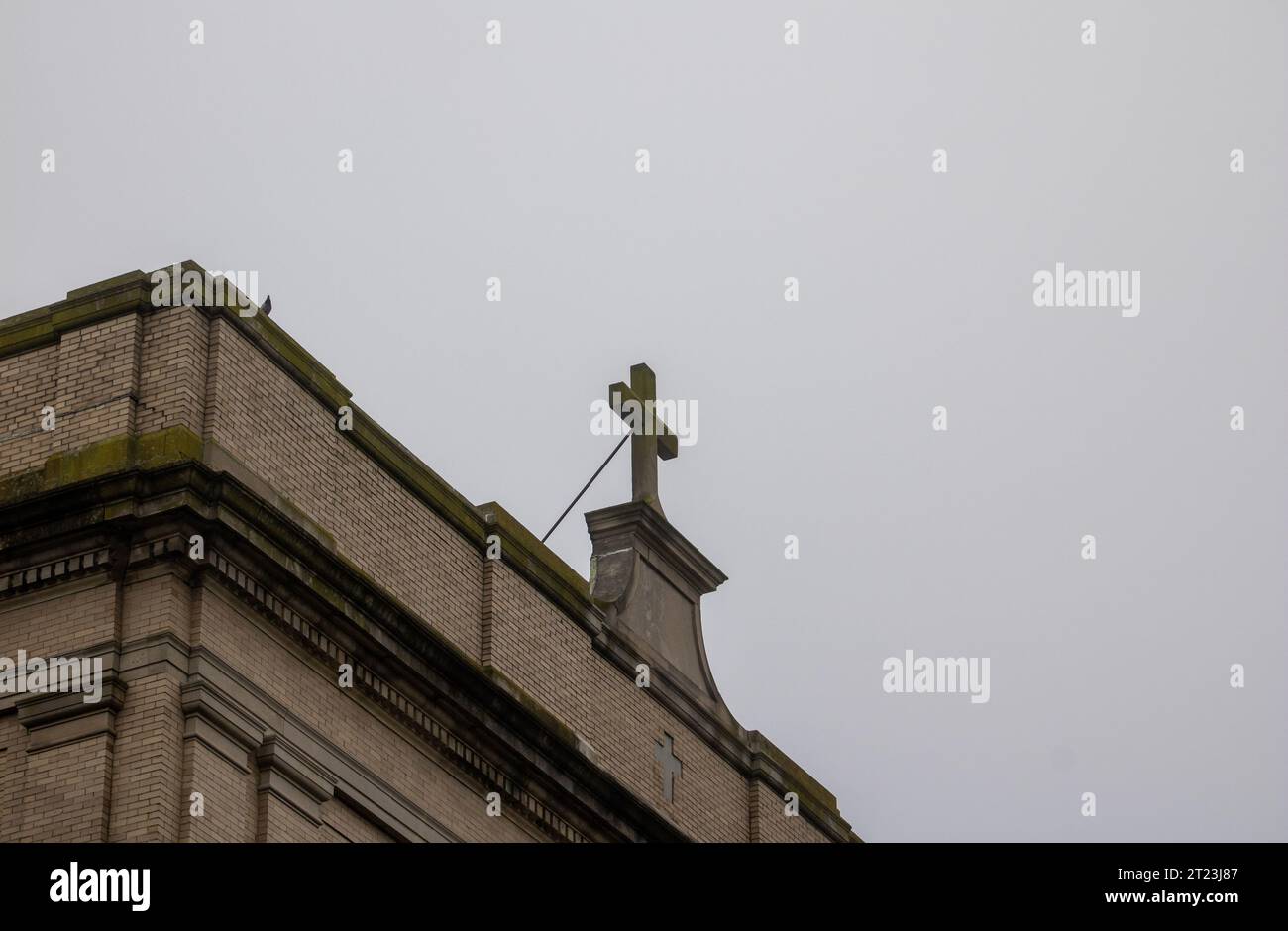 An architectural image depicting a tall building with a cross on the ...