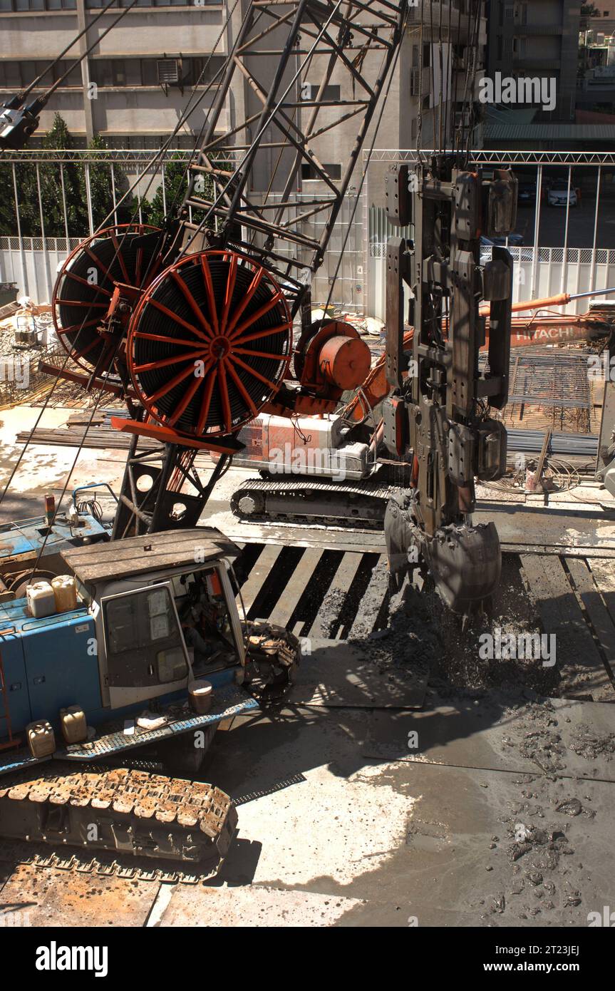 Digger working in a building site during construction of a new office ...