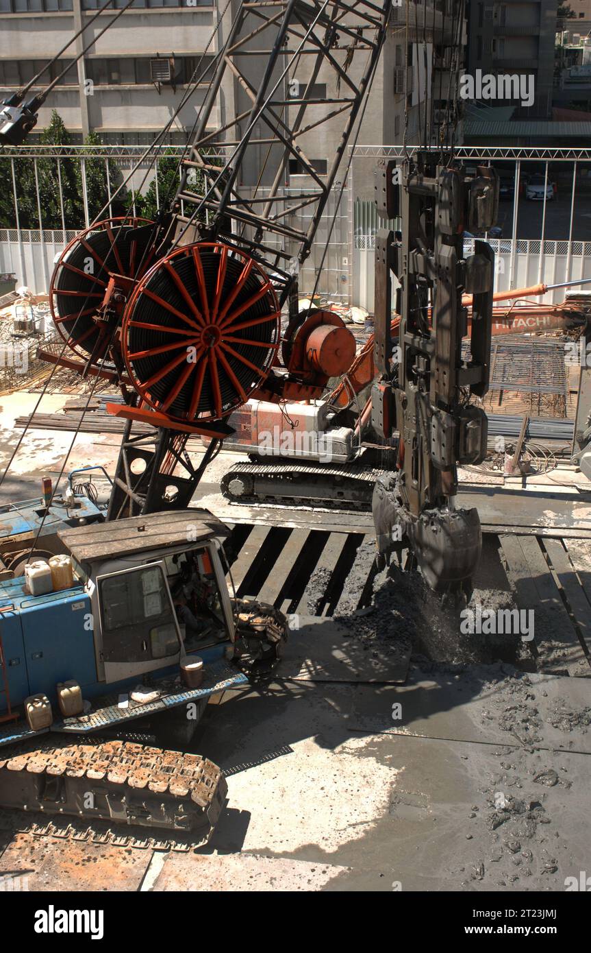 Digger working in a building site during construction of a new office ...