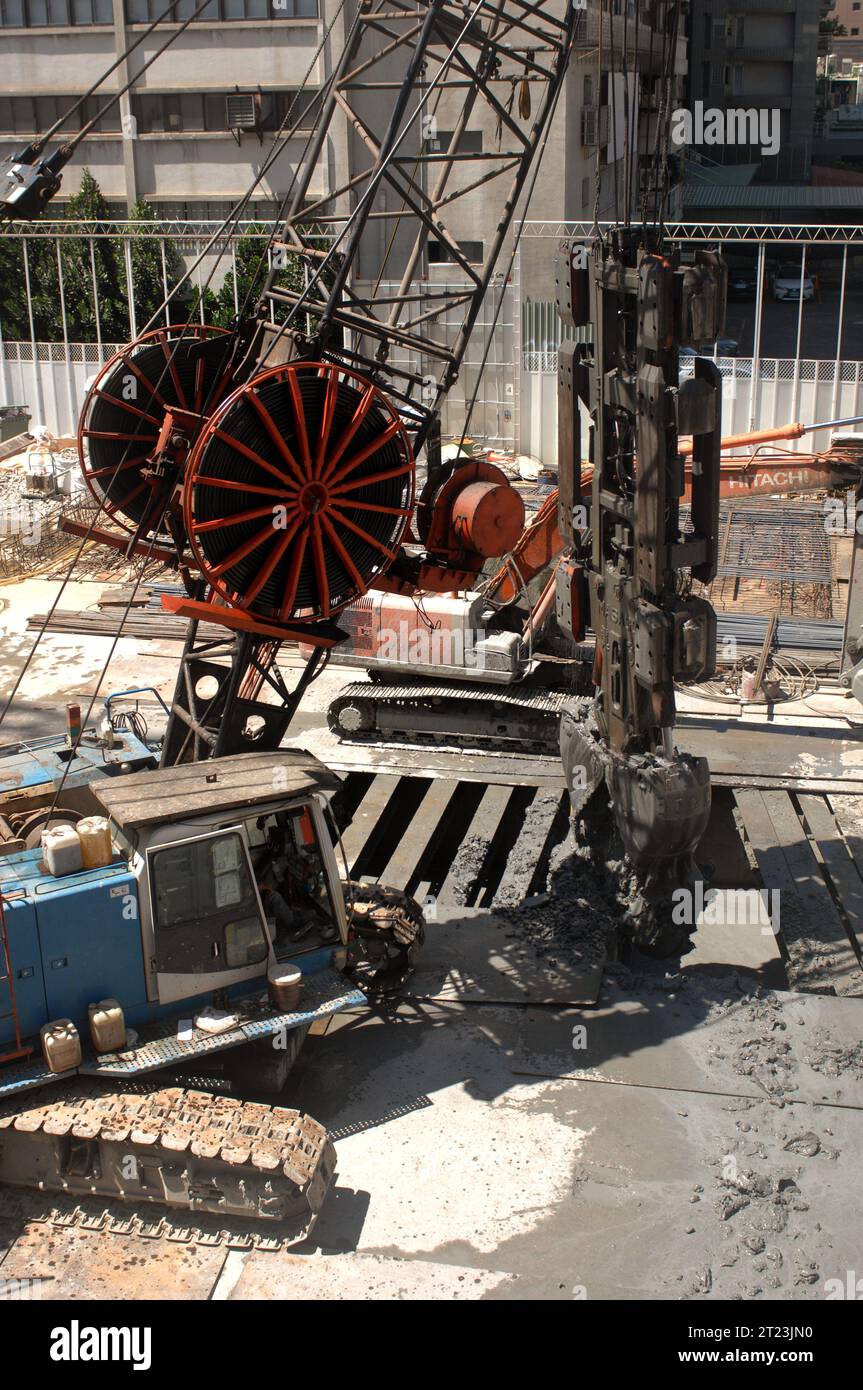 Digger working in a building site during construction of a new office ...
