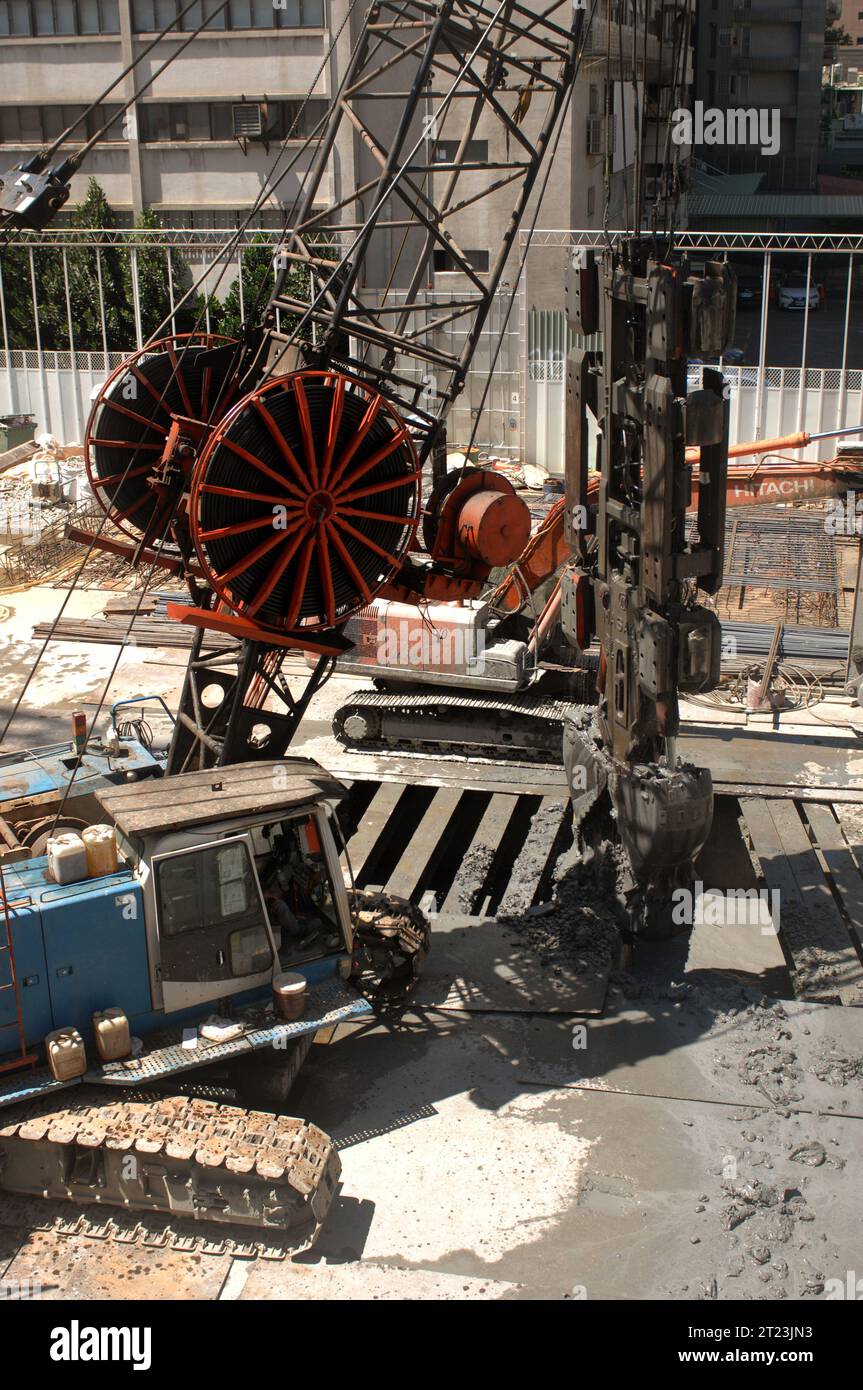 Digger working in a building site during construction of a new office ...