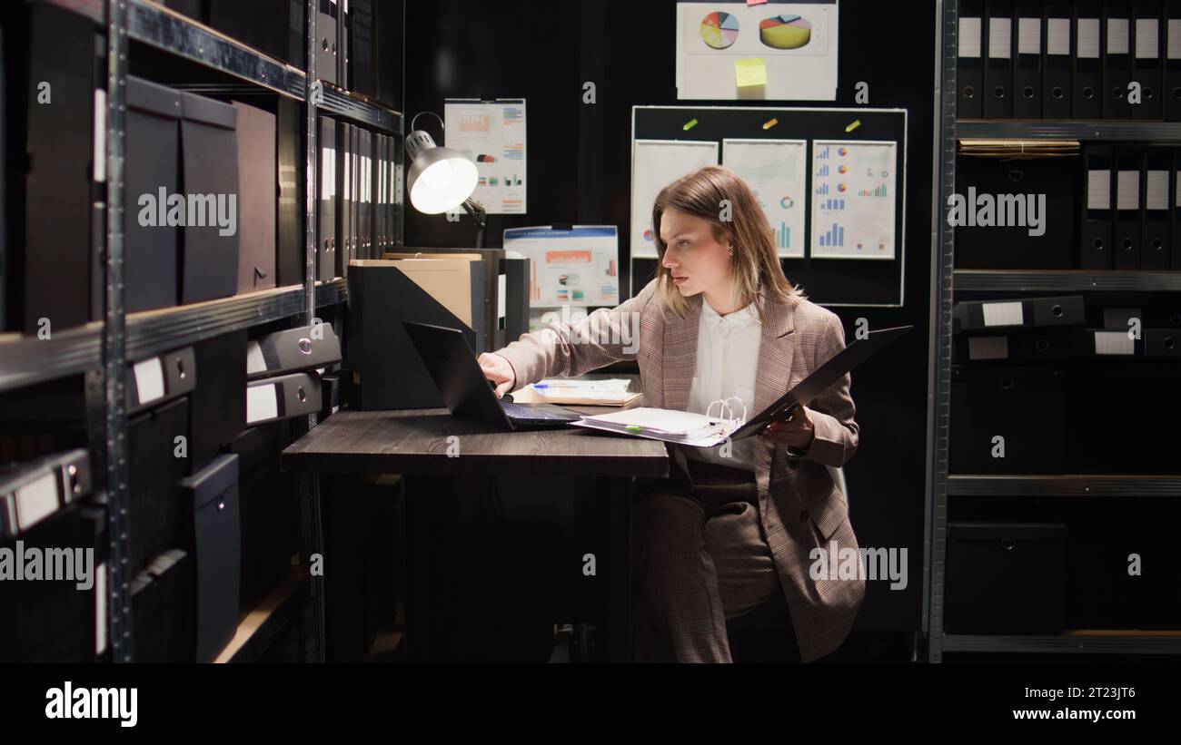 Law officer entering room, using laptop to analyze clues and perform ...