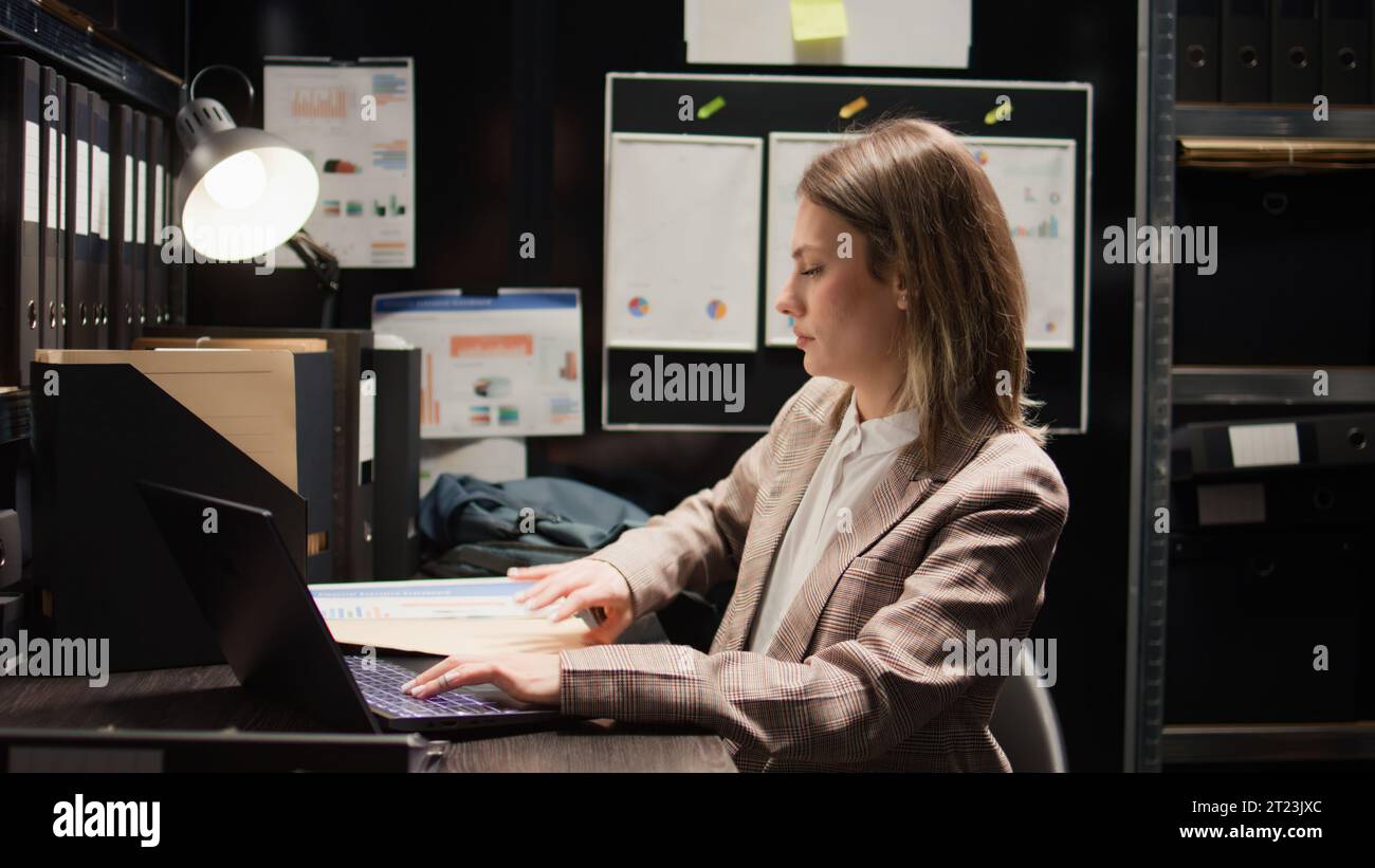 Female private detective stands and goes out of the office, carrying ...