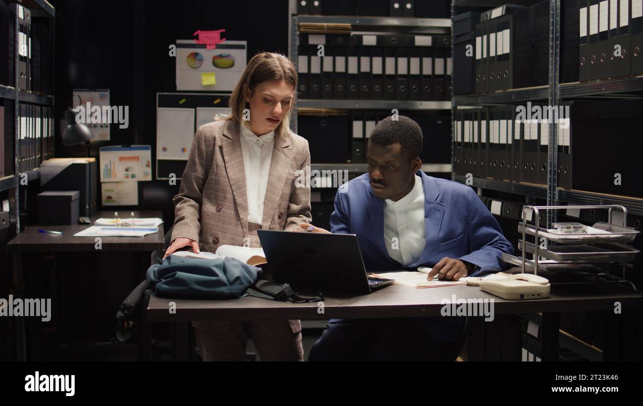 African american and caucasian police officers conduct thorough ...