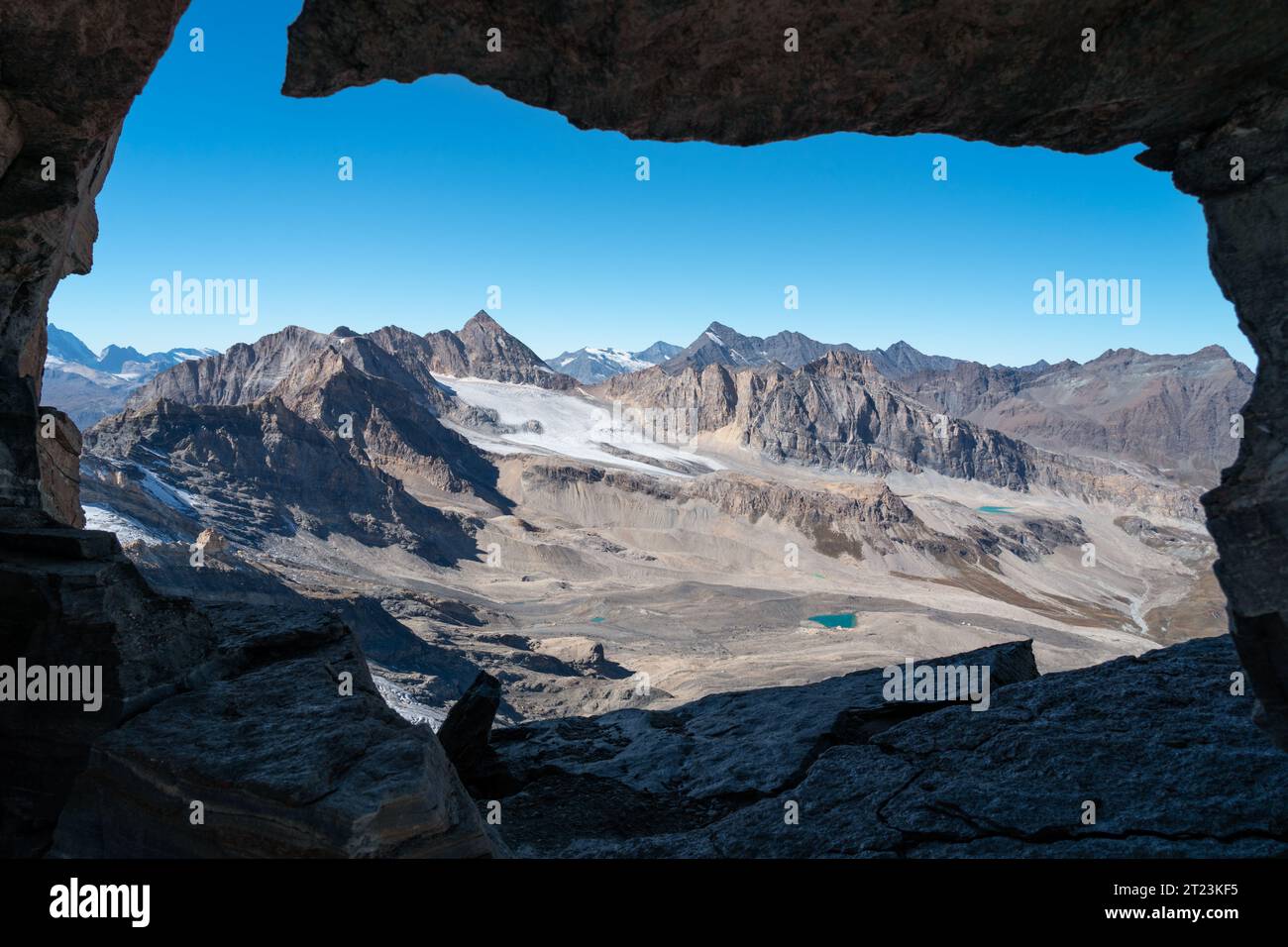 view from inside a cave on top of the mountain of rocky landscape ...