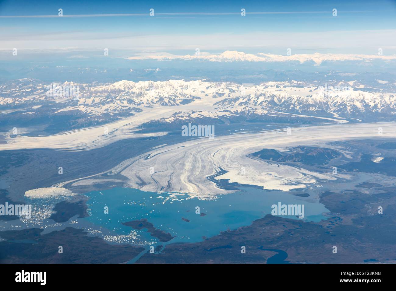Aerial view of a large glacier field flowing down the valleys of a ...