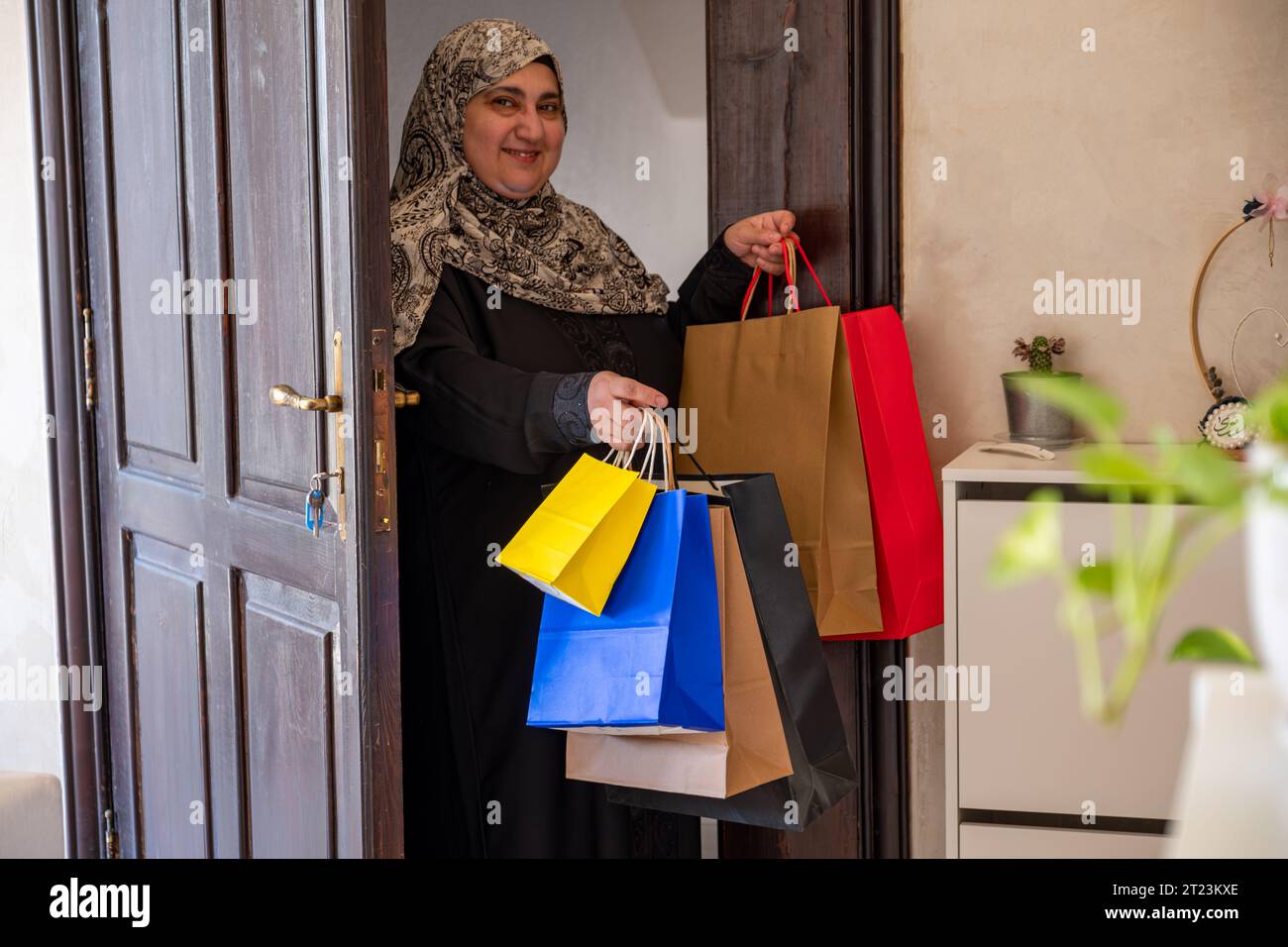 Arabic woman from jordan middle east holding shopping bags and entering ...