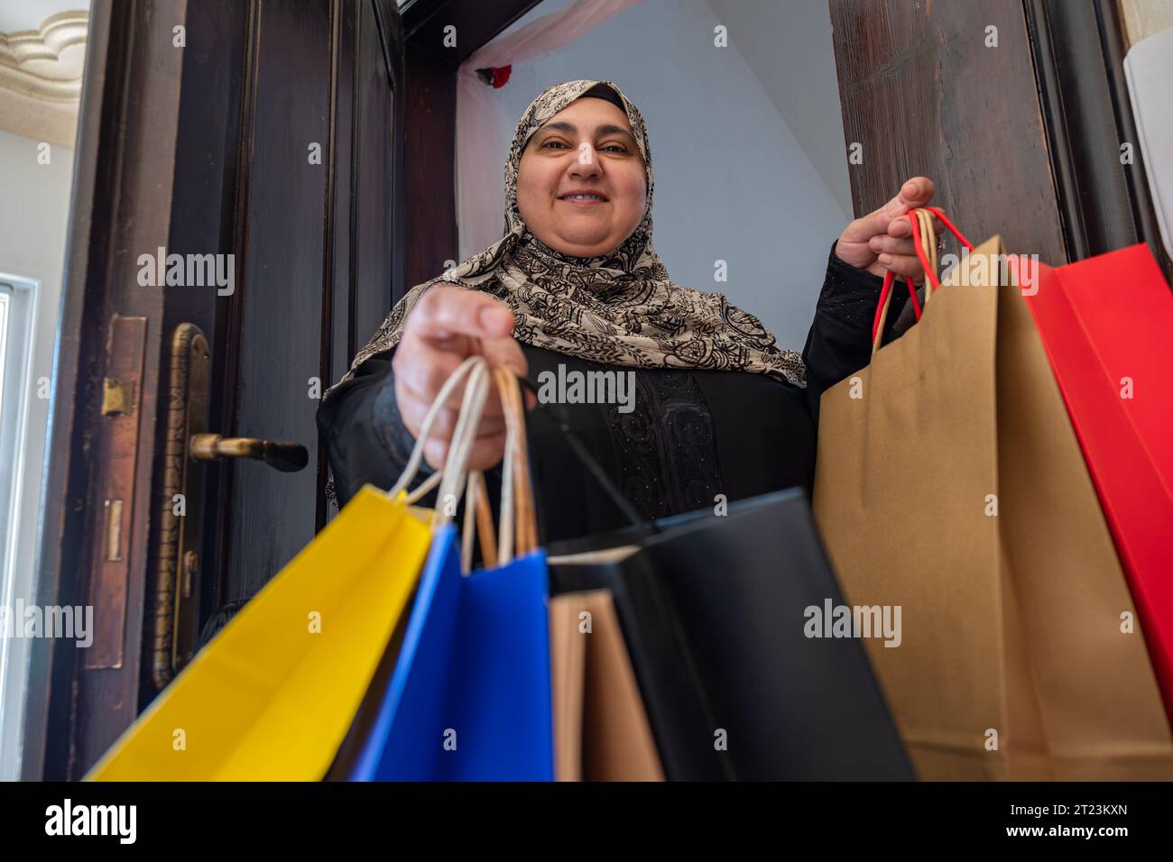 Arabic woman from jordan middle east holding shopping bags and entering ...