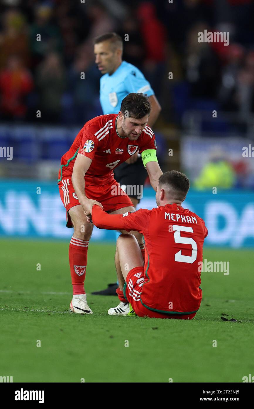 Cardiff, UK. 15th Oct, 2023. Ben Davies of Wales helps up Chris Mepham ...
