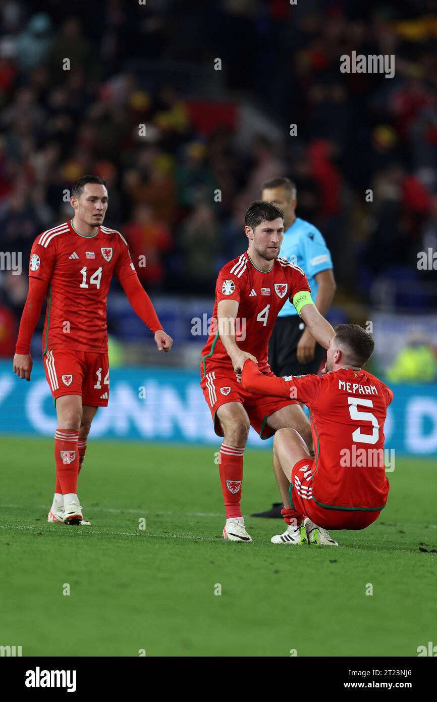 Cardiff, UK. 15th Oct, 2023. Ben Davies of Wales helps up Chris Mepham ...