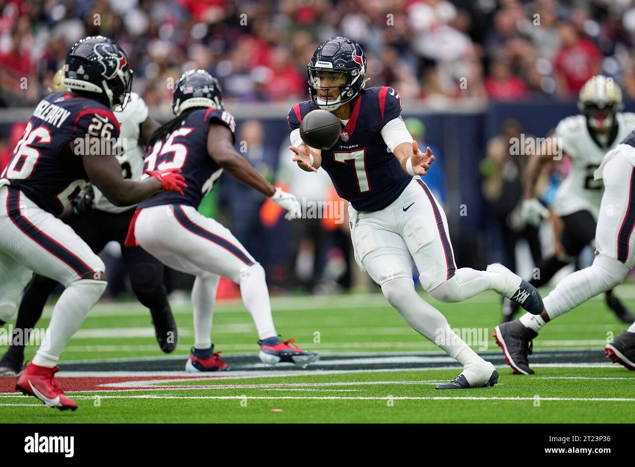 Houston Texans quarterback C.J. Stroud (7) pitches the ball to running ...