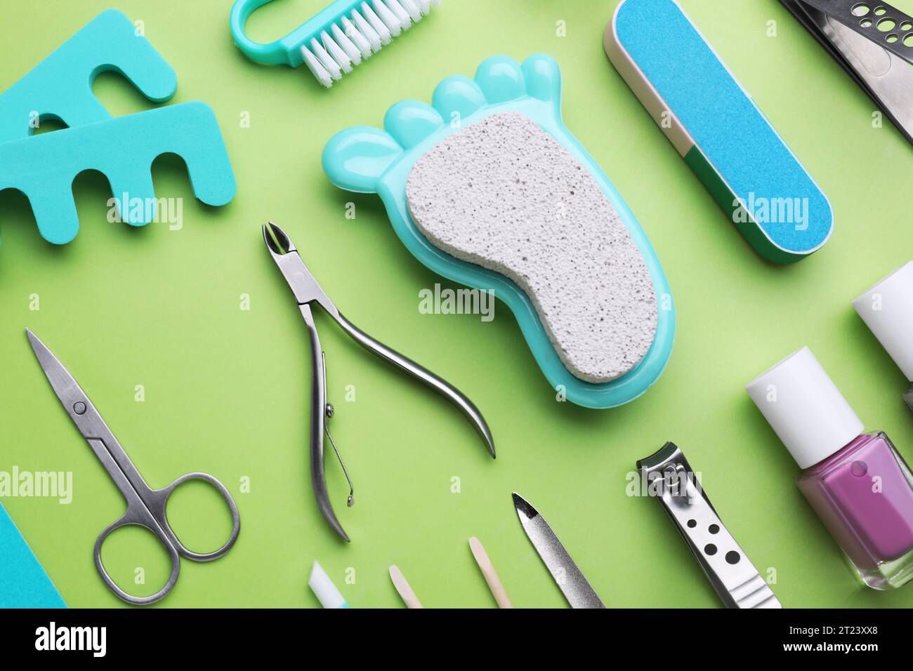 Set of pedicure tools on light green background, flat lay Stock Photo ...