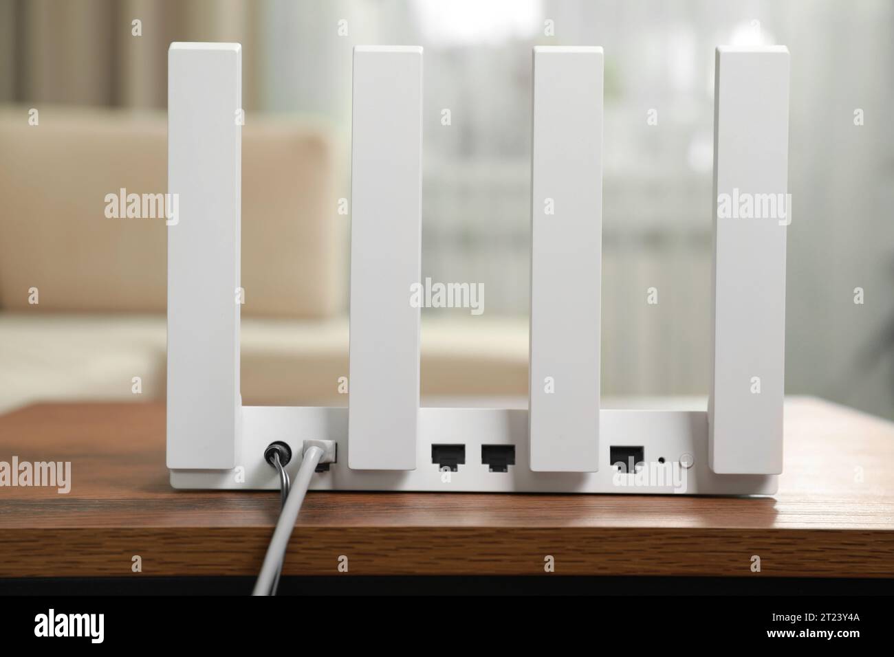 New modern Wi-Fi router on wooden table indoors Stock Photo - Alamy