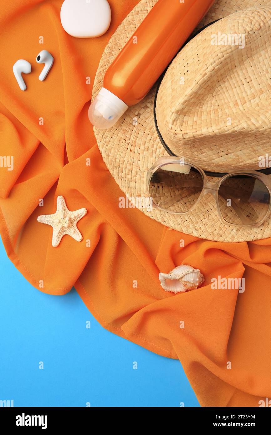 Flat lay composition with beach accessories on light blue background ...