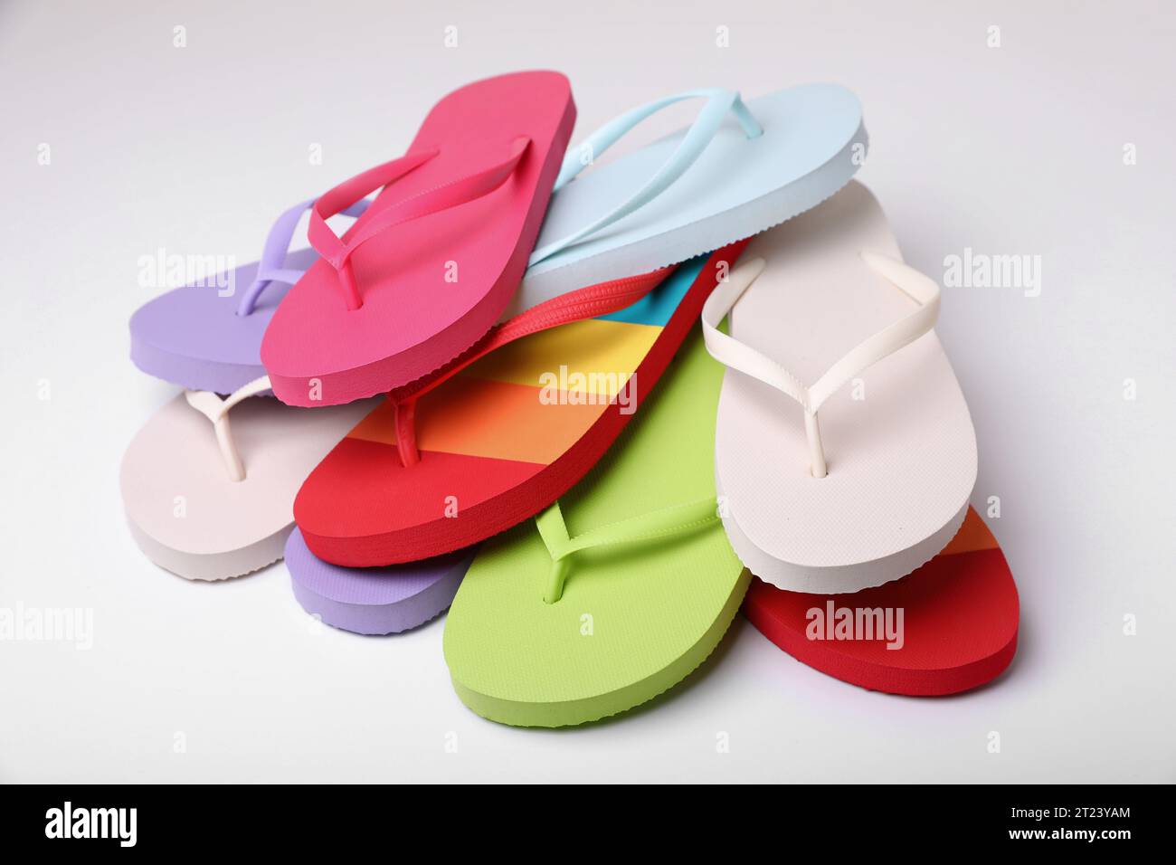 Many different flip flops on white background Stock Photo - Alamy