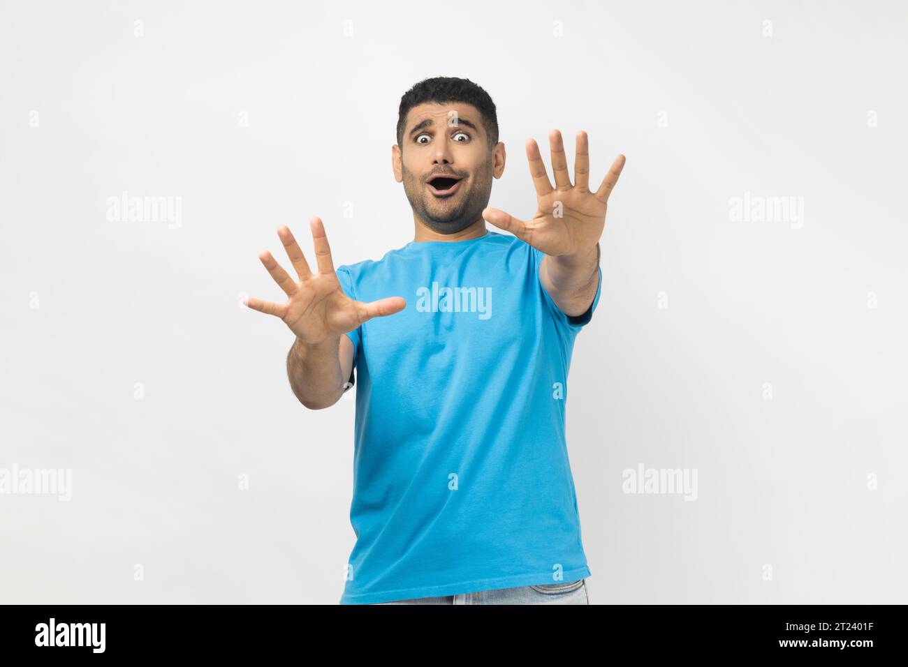 Portrait of scared shocked frighten unshaven man wearing blue T- shirt ...
