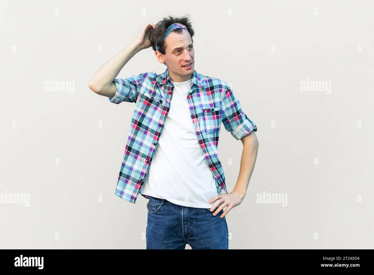 Indignant puzzled man rubbing head, tries to remember necessary ...