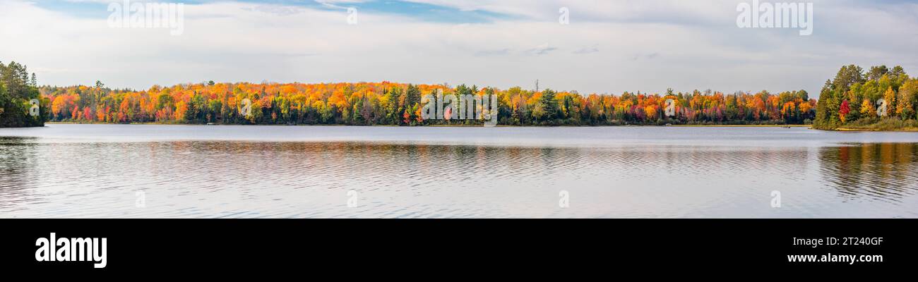 Colorful autumn trees on lake of the Falls in Mercer, Wisconsin ...