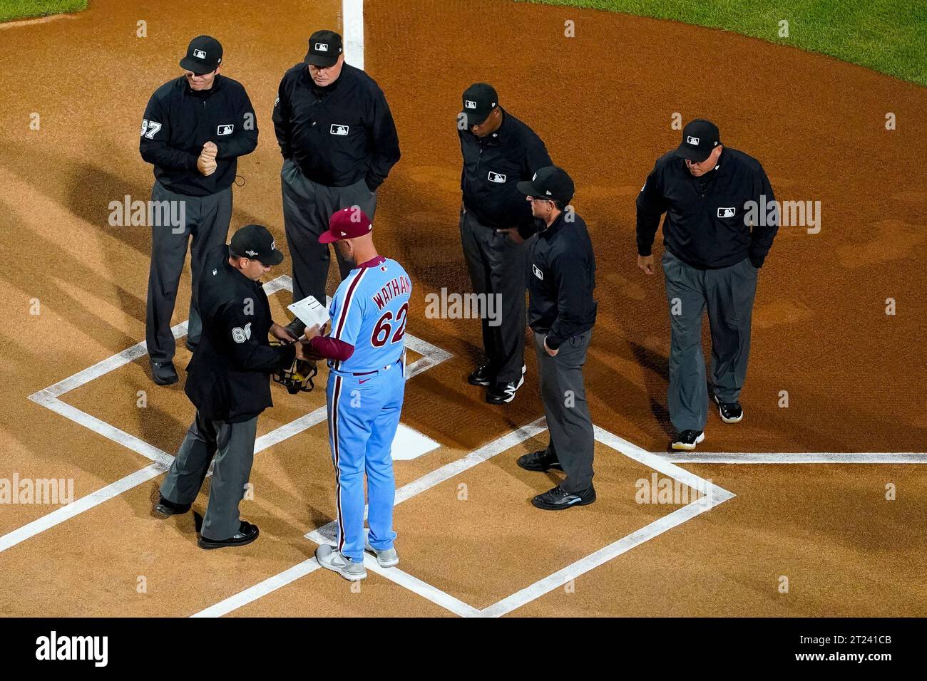 Philadelphia Phillies third base coach Dusty Wathan (62) hands the ...