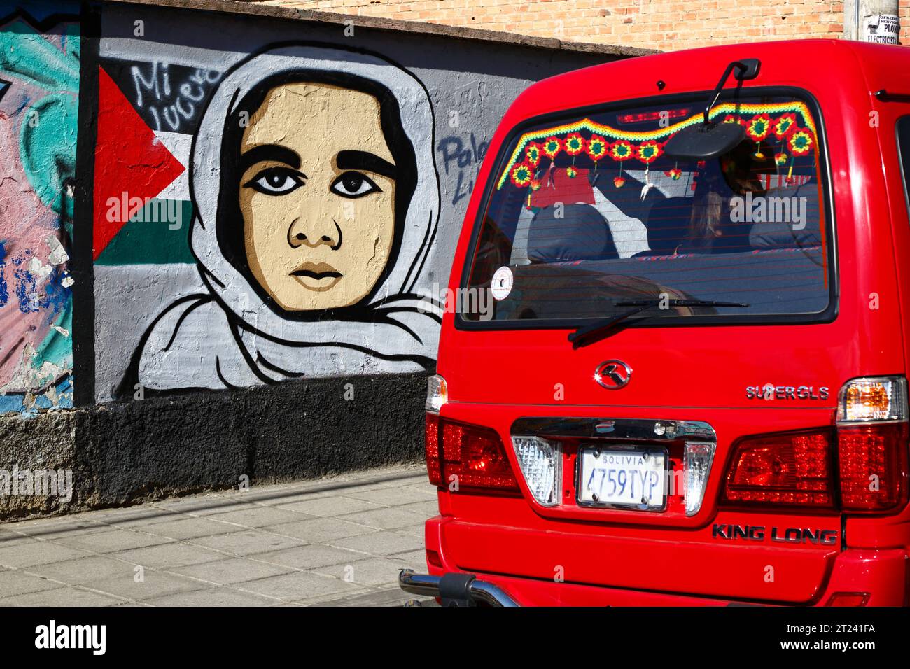 A red minibus decorat4ed with rosettes in the colours of the Bolivian ...