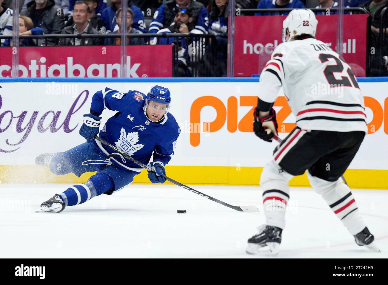 Toronto Maple Leafs center Noah Gregor (18) is tripped as Chicago ...
