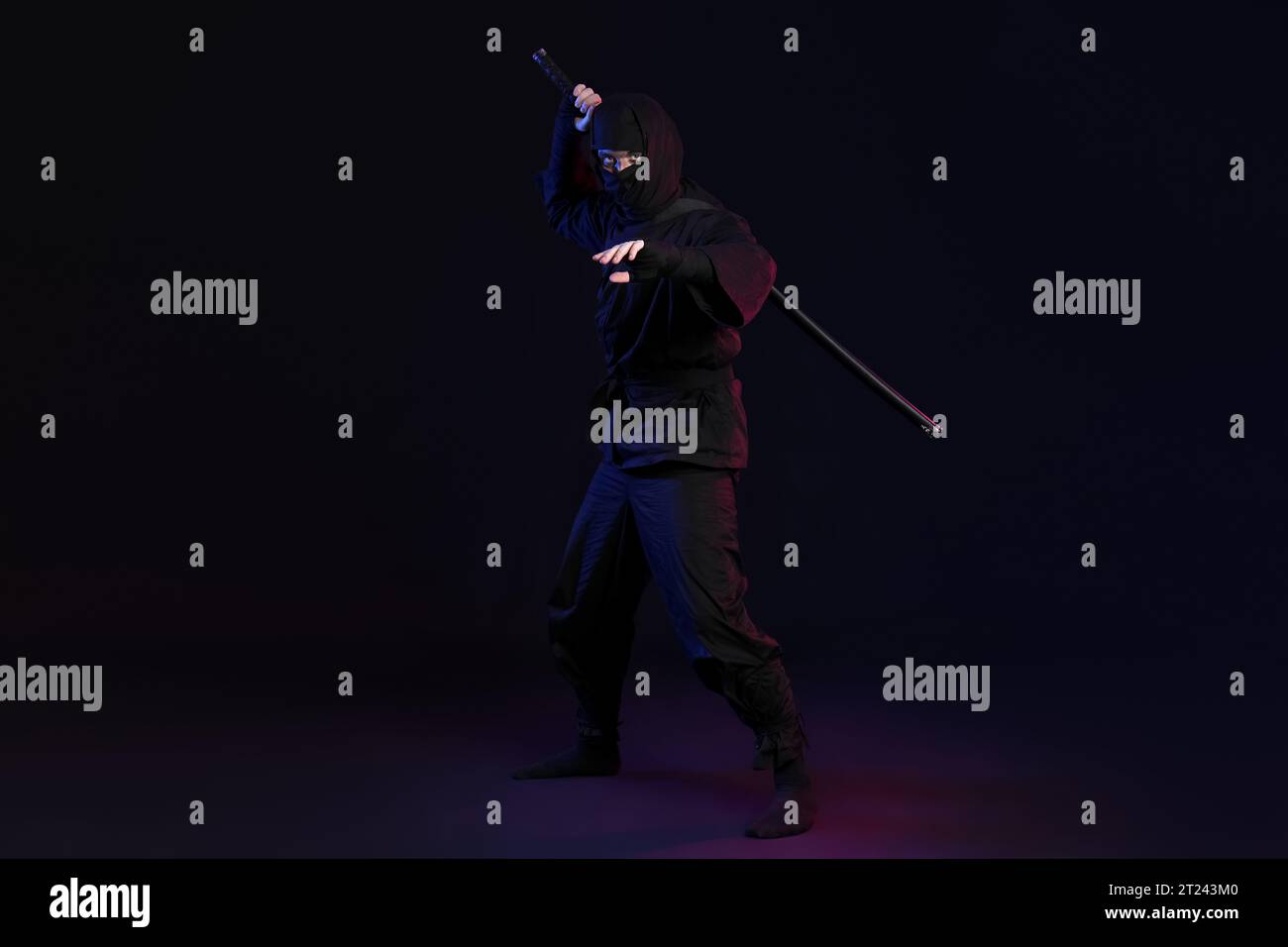 Male ninja with sword on dark background Stock Photo - Alamy