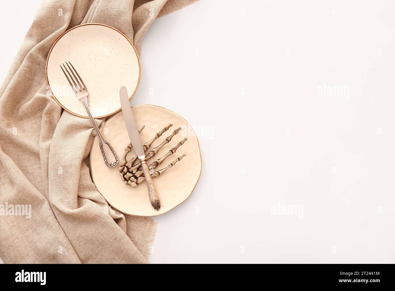Halloween table setting with skeleton hand on light background Stock ...