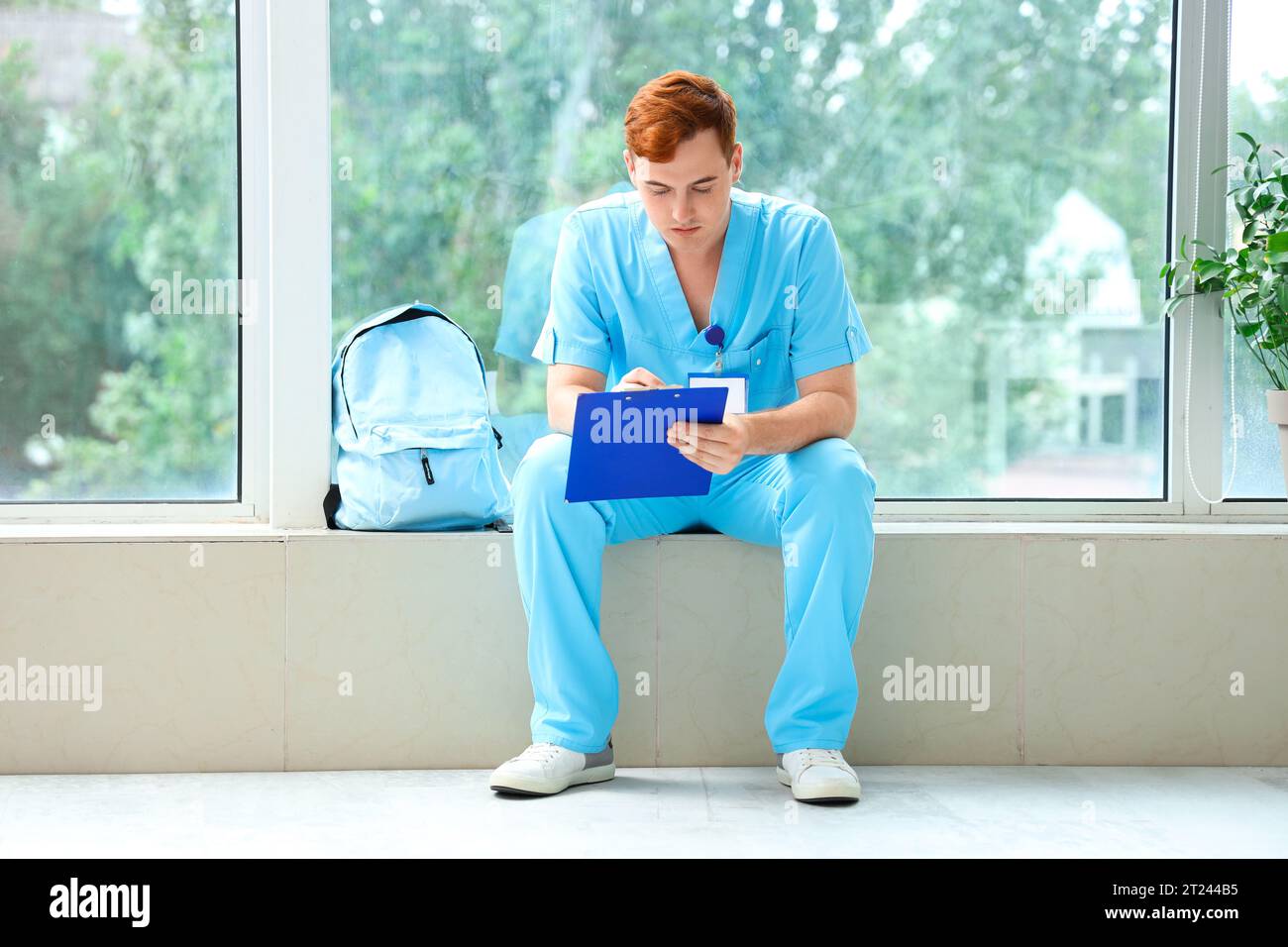 Male medical student with clipboard in clinic Stock Photo - Alamy