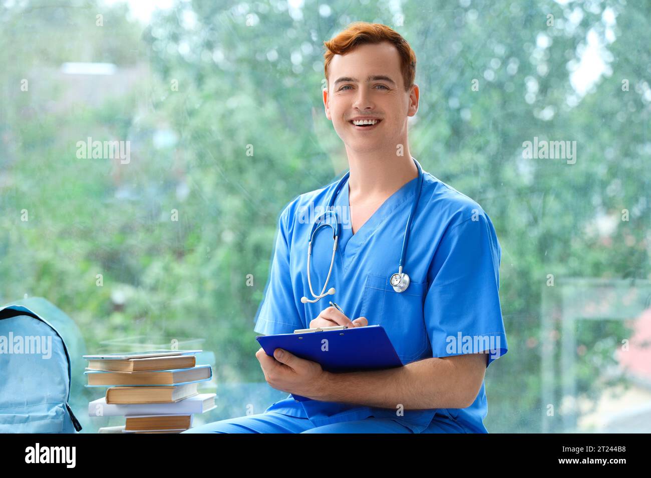 Male medical student with clipboard at university Stock Photo - Alamy