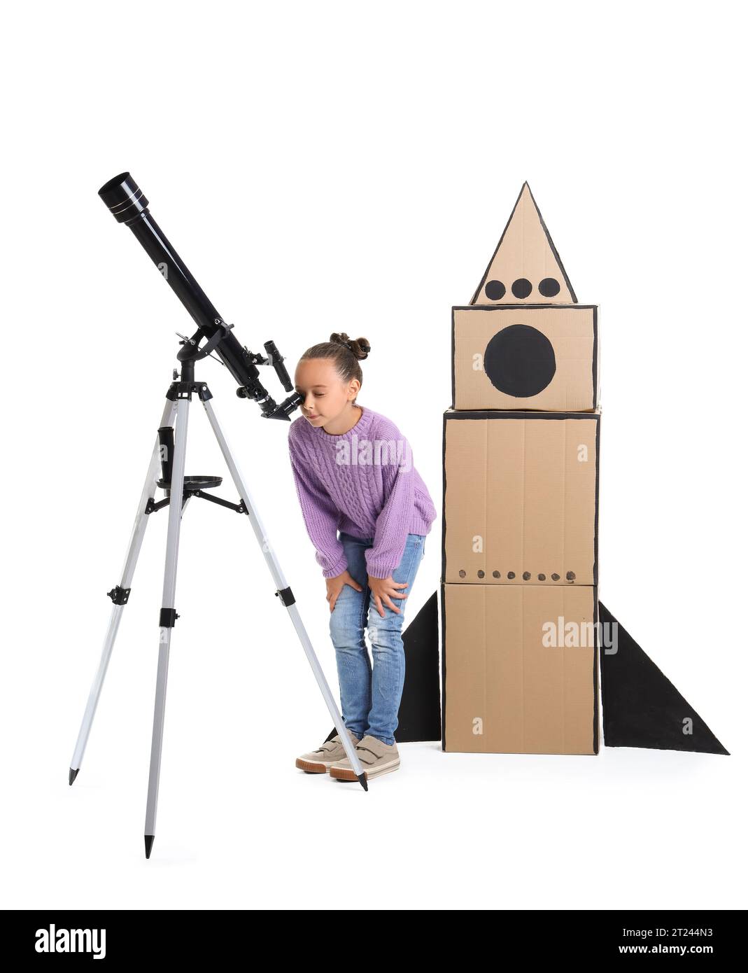Cute little girl with telescope and cardboard rocket on white ...
