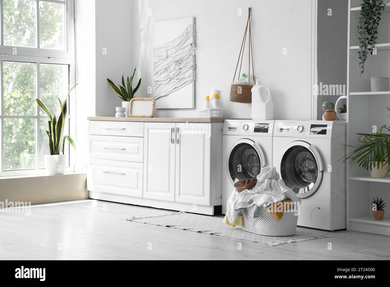 Interior of laundry room with washing machines and dirty clothes Stock ...
