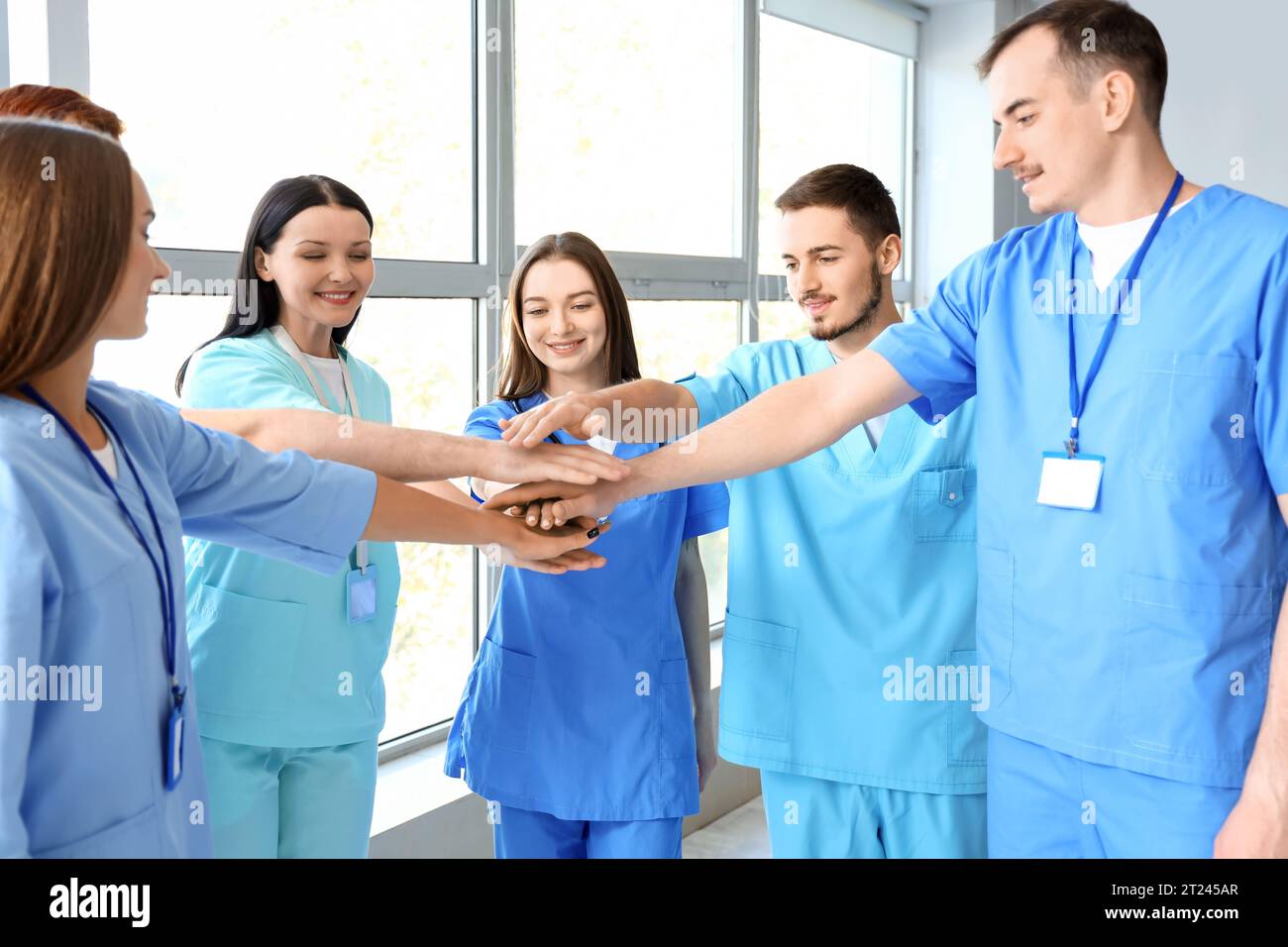 Group of medical students putting hands together at university Stock ...