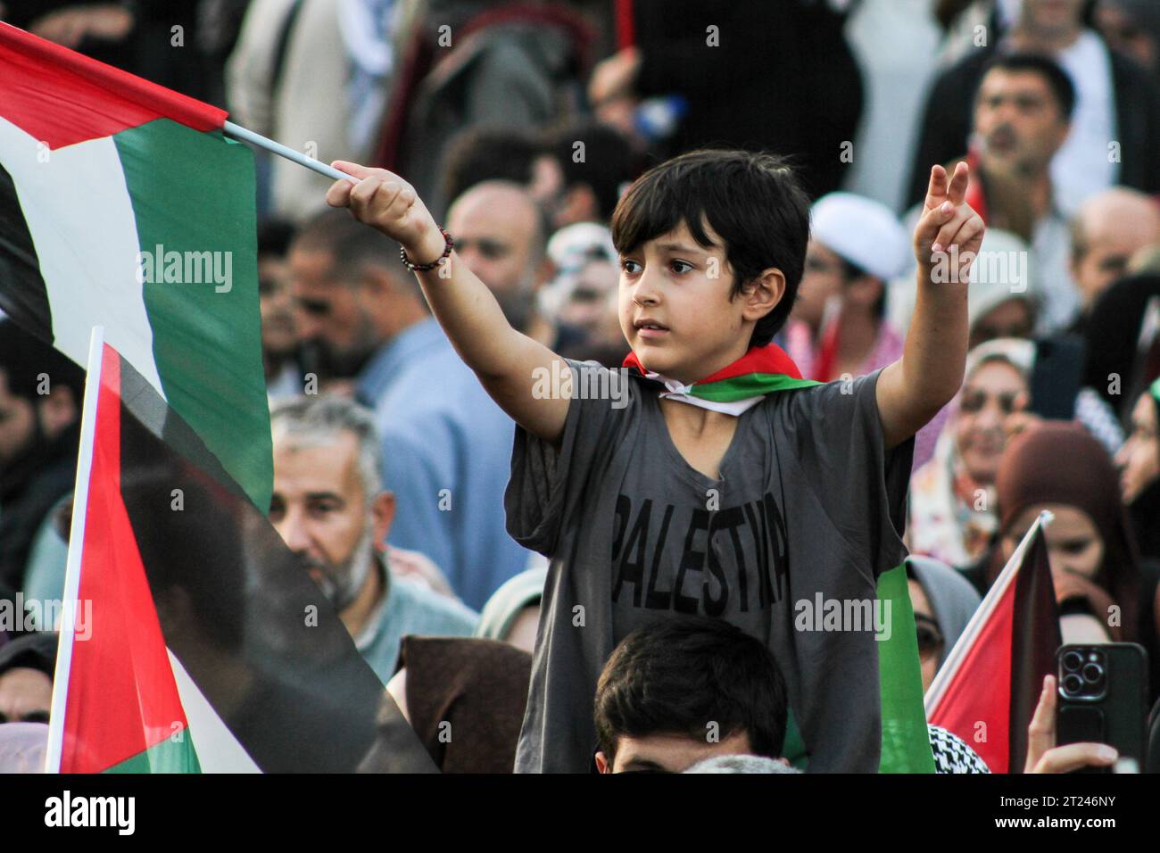 Istanbul, Turkey. 14th Oct, 2023. A child raises a victory sign with ...