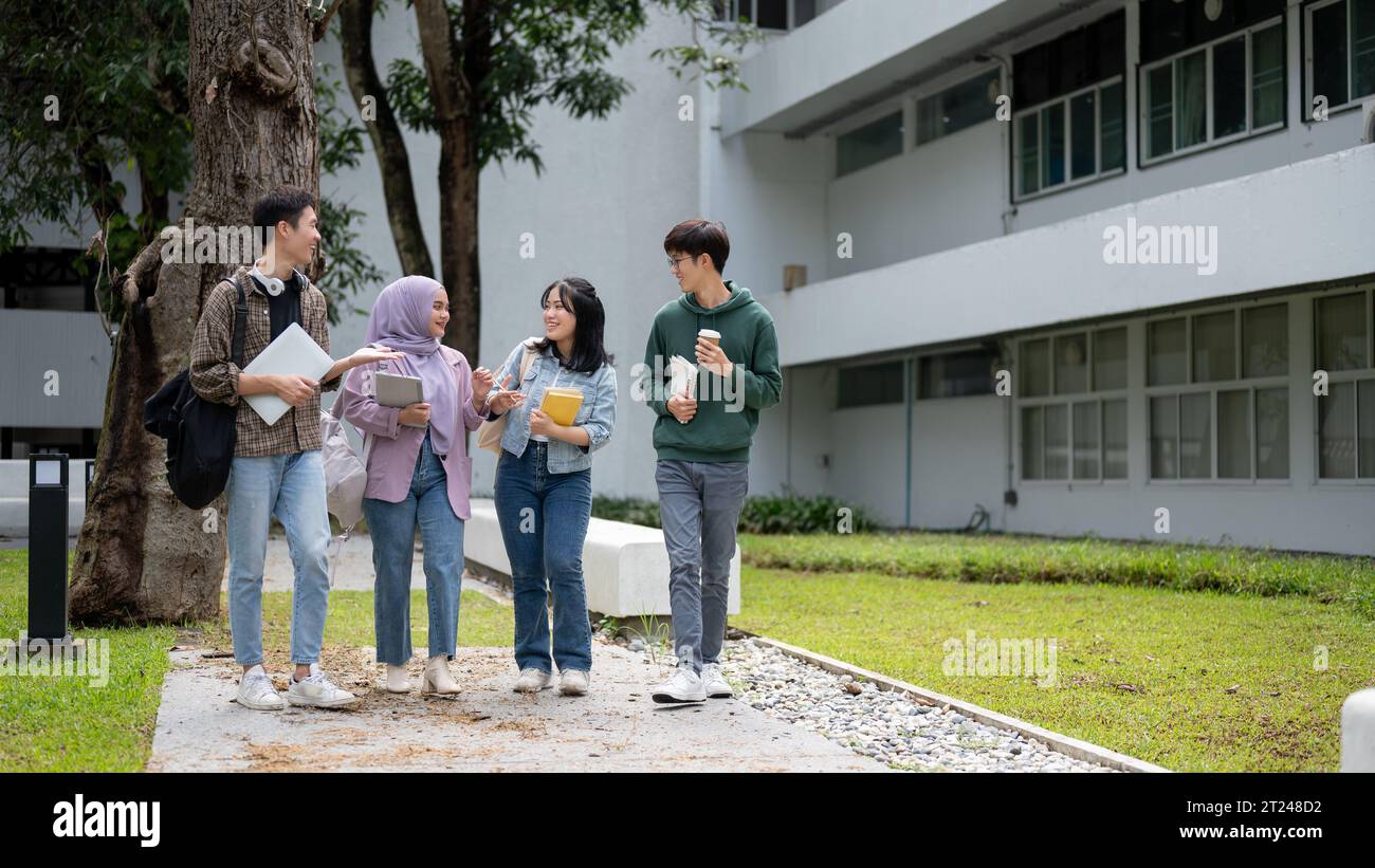 A group of cheerful, diverse Asian university students are enjoying ...