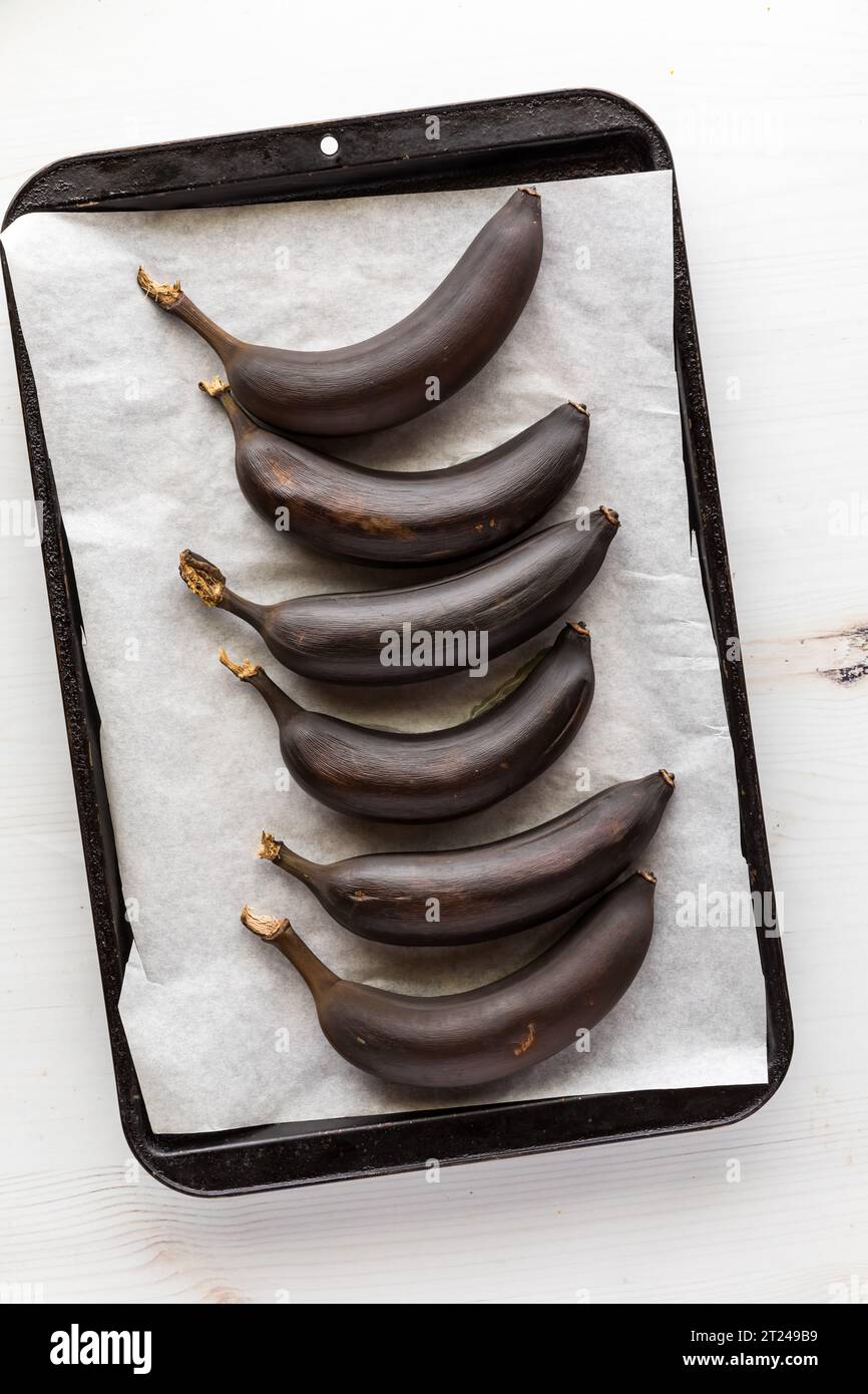 Black roasted bananas in their peel fresh out of the oven Stock Photo ...